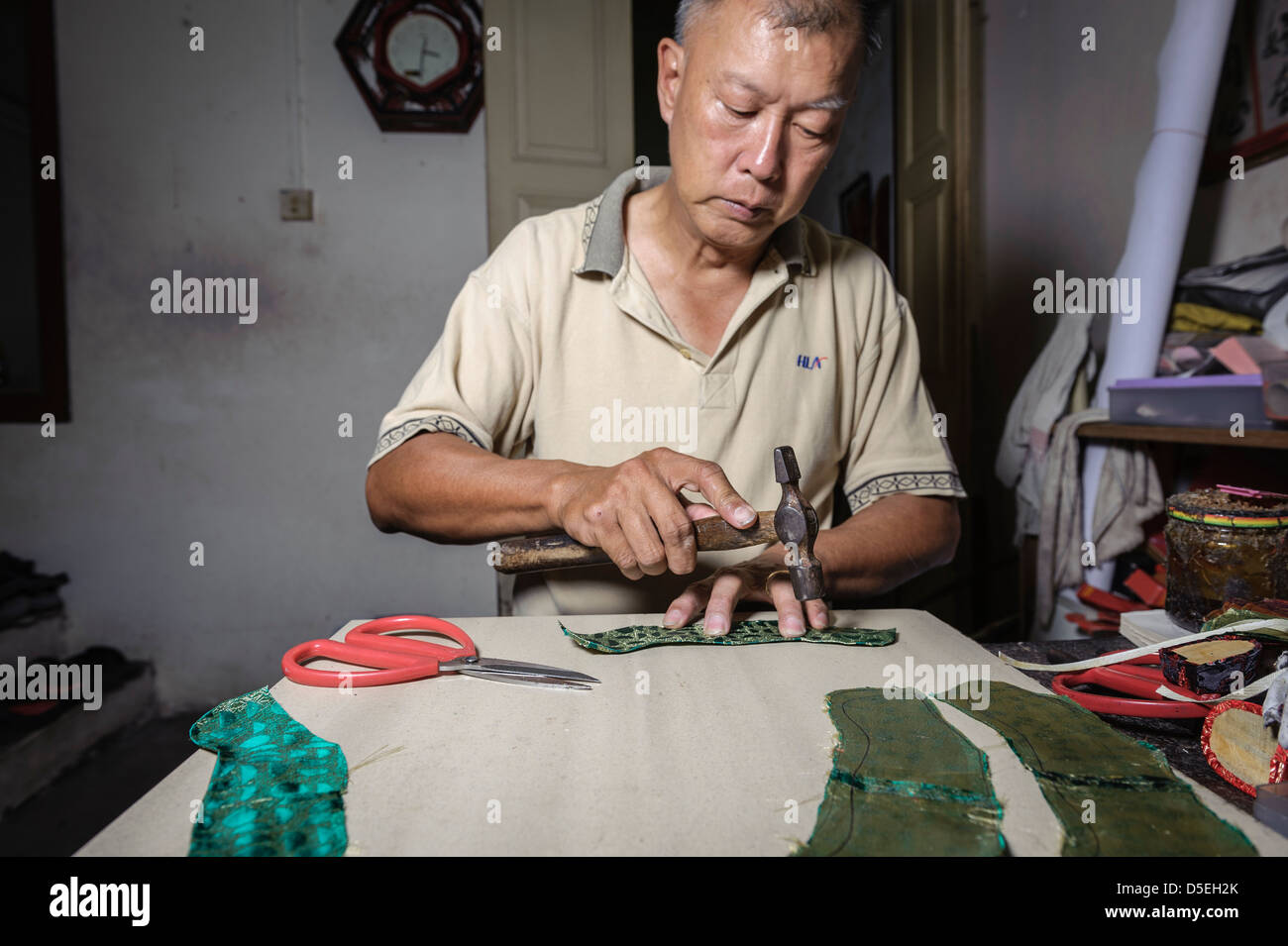 Artisan making shoes for "bound feet", Melaka, Malaysia, Asia Stock ...
