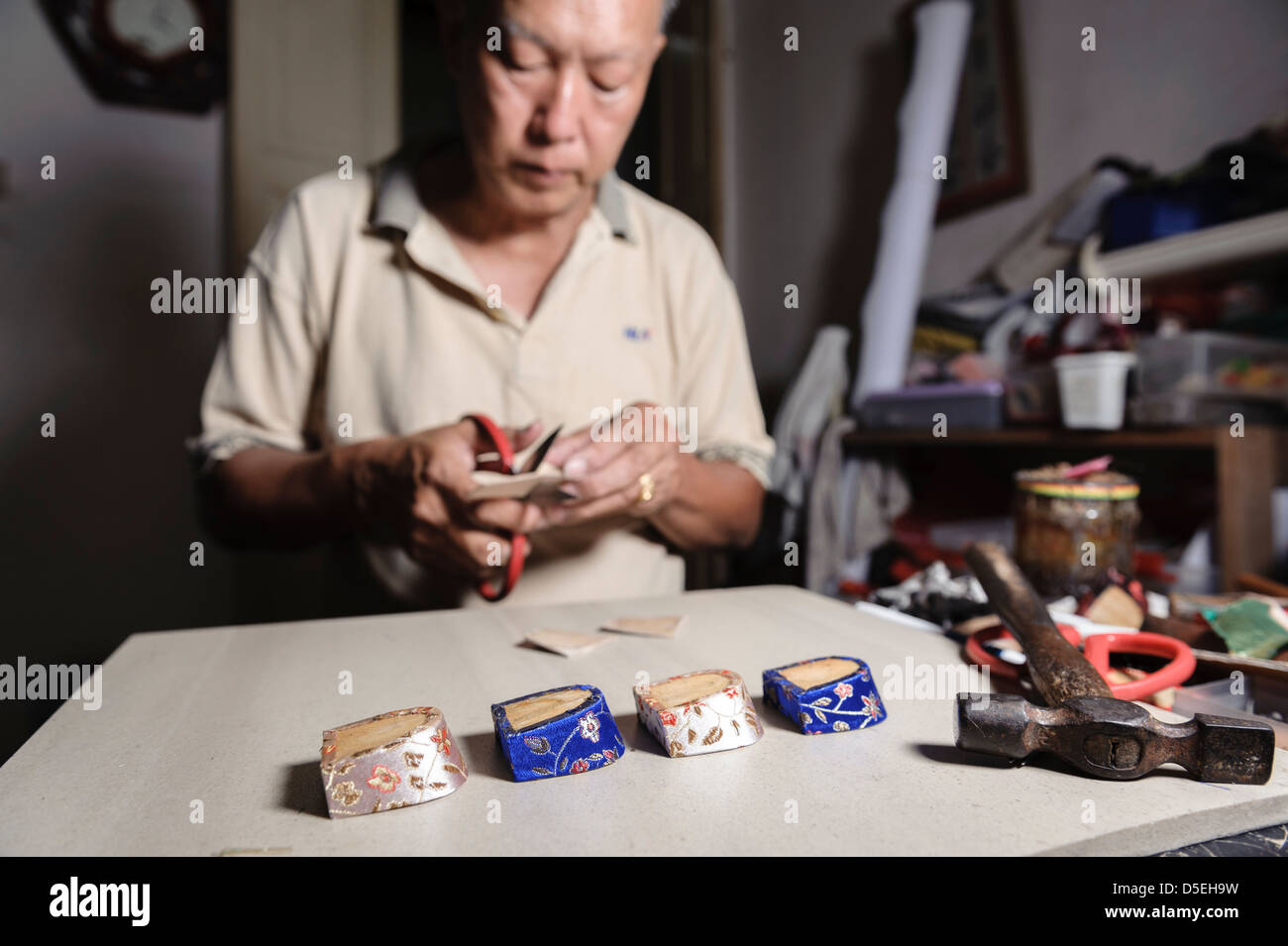 Artisan making shoes for "bound feet", Melaka, Malaysia, Asia Stock ...