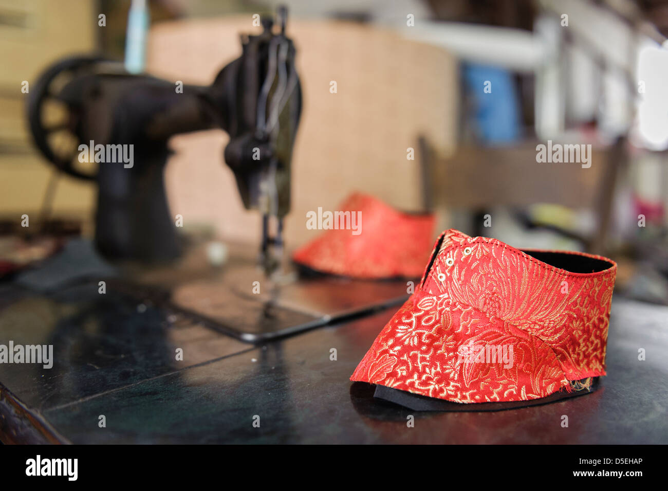 Artisan making shoes for "bound feet", Melaka, Malaysia, Asia Stock ...