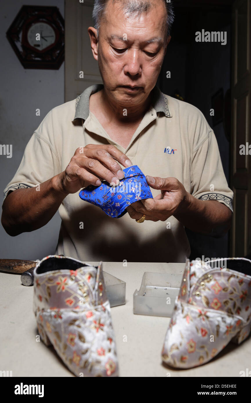 Artisan making shoes for "bound feet", Melaka, Malaysia, Asia Stock ...