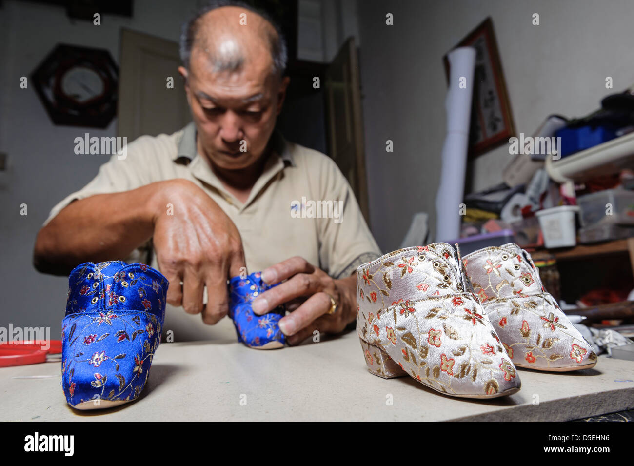 Artisan making shoes for "bound feet", Melaka, Malaysia, Asia Stock ...