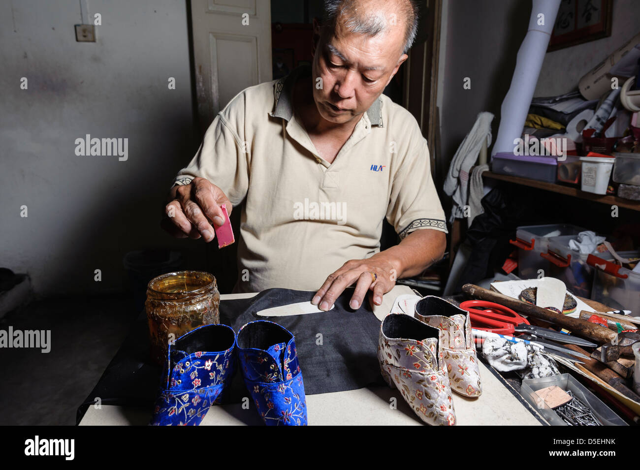 Artisan making shoes for "bound feet", Melaka, Malaysia, Asia Stock ...