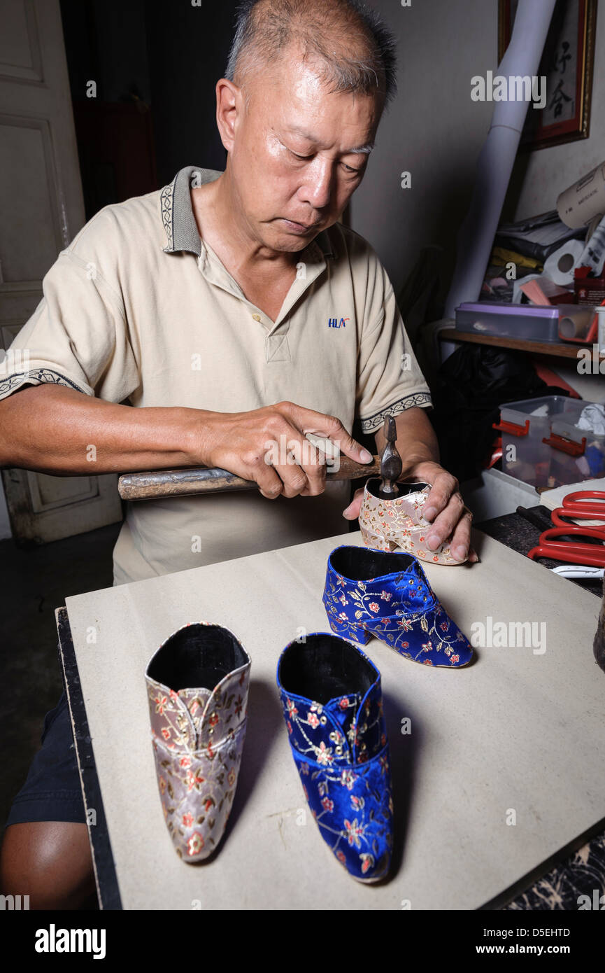Artisan making shoes for "bound feet", Melaka, Malaysia, Asia Stock ...