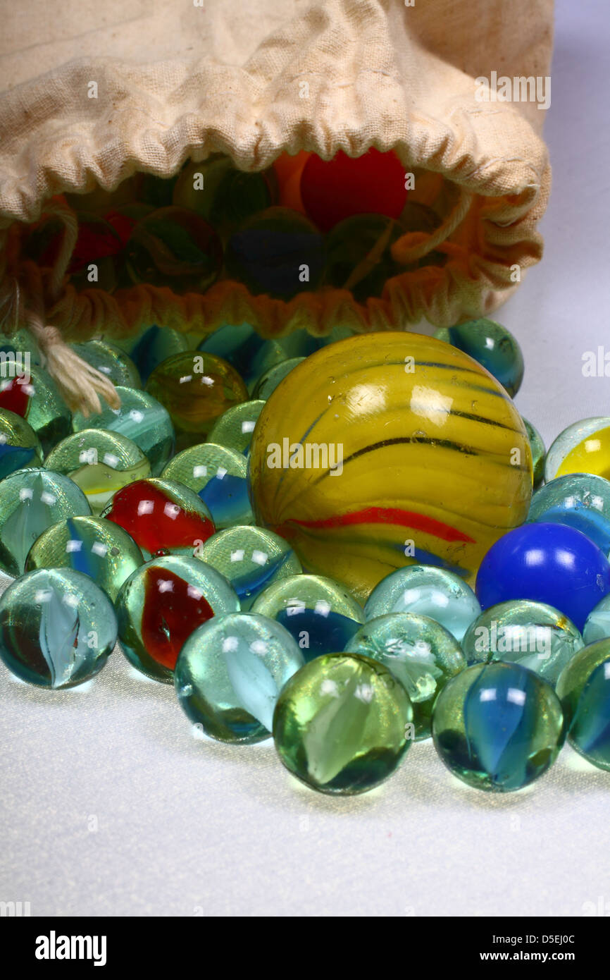 Marbles spilling out of drawstring bag Stock Photo - Alamy