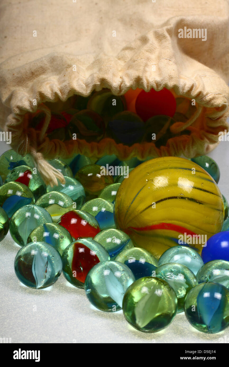 Marbles spilling out of drawstring bag Stock Photo - Alamy