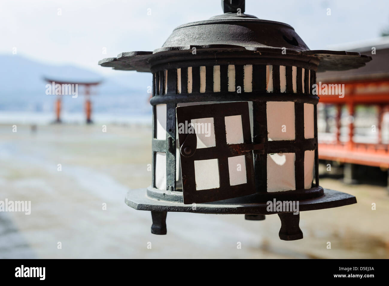 Detail of a lantern with the Grand Torii in the background, Itsukushima ...