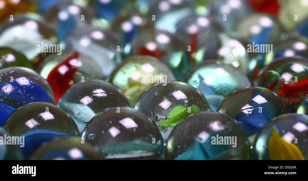 Colourful marbles on a white background Stock Photo - Alamy