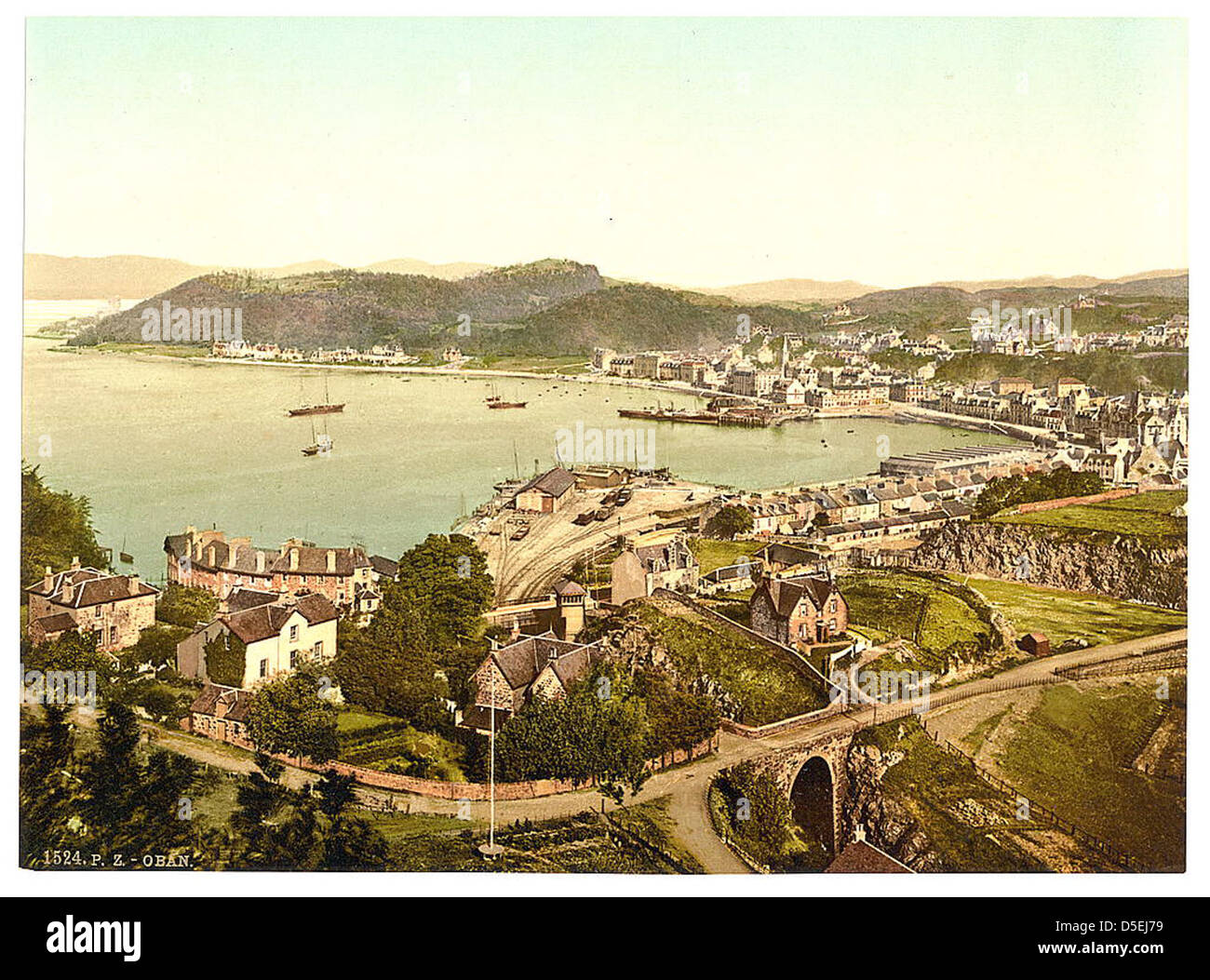 A view of Oban, Scotland, showing the harbor and surrounding hills. The ...