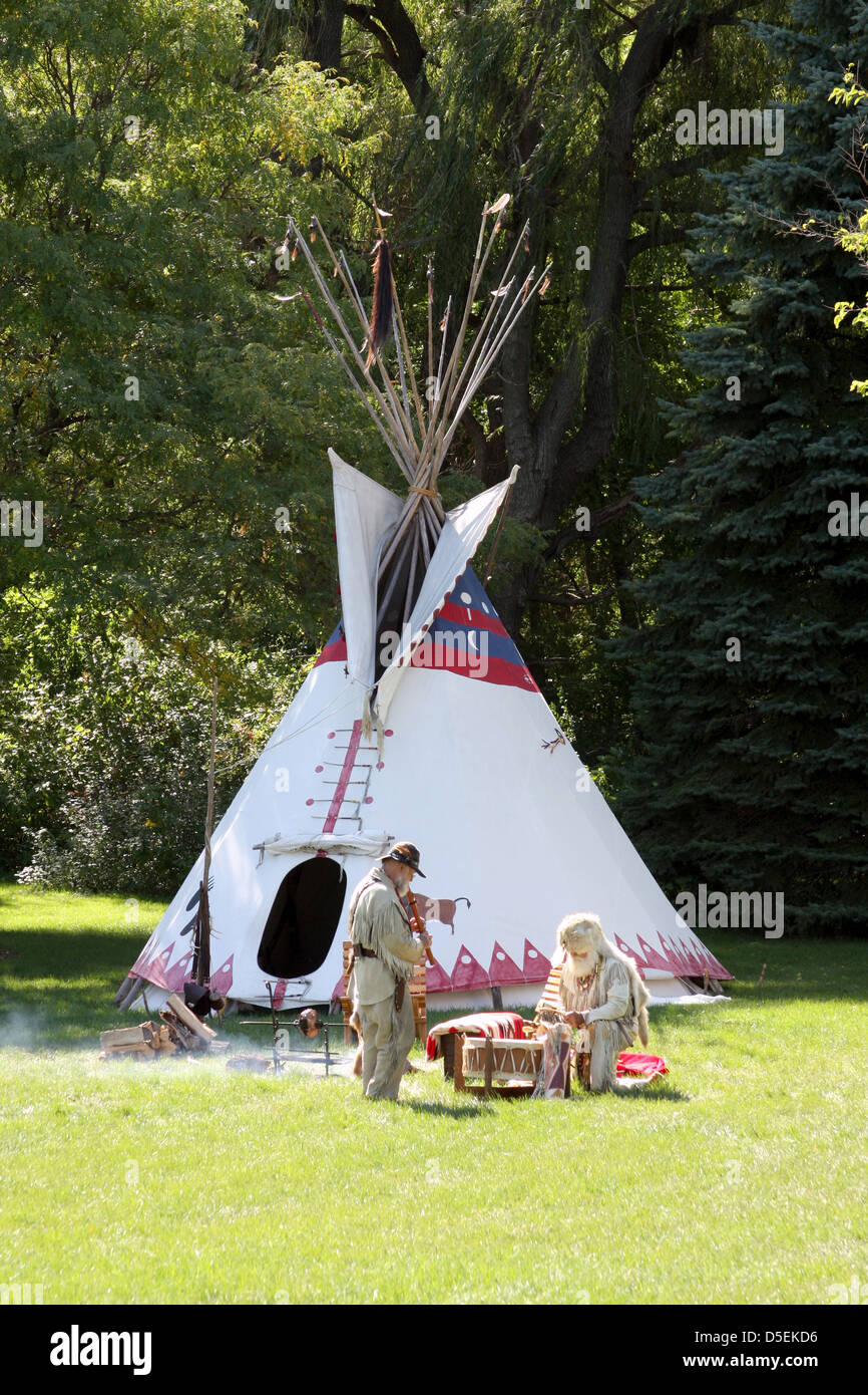 A Native American scene with men playing drums and a flute Stock Photo ...