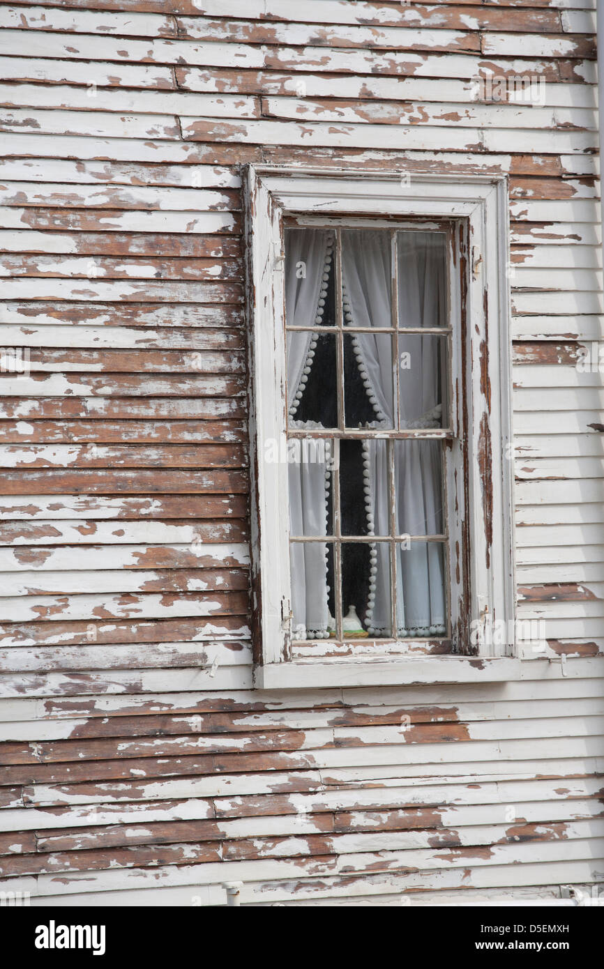 Peeling white paint on side of old timber panelled house called The ...