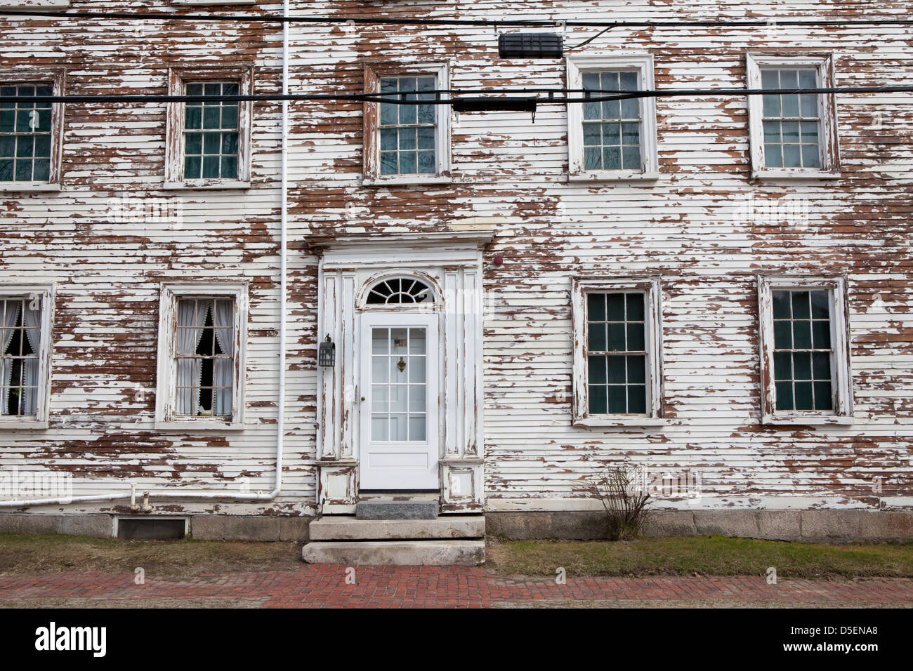 Peeling white paint on side of old timber panelled house called The ...