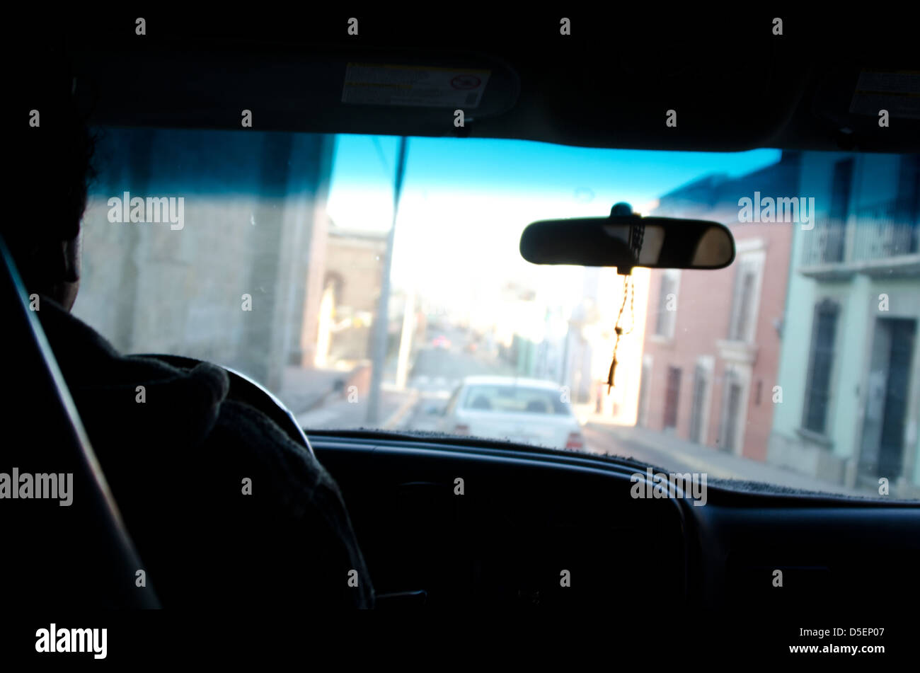 Looking through the windshield of a car driving through the streets of ...