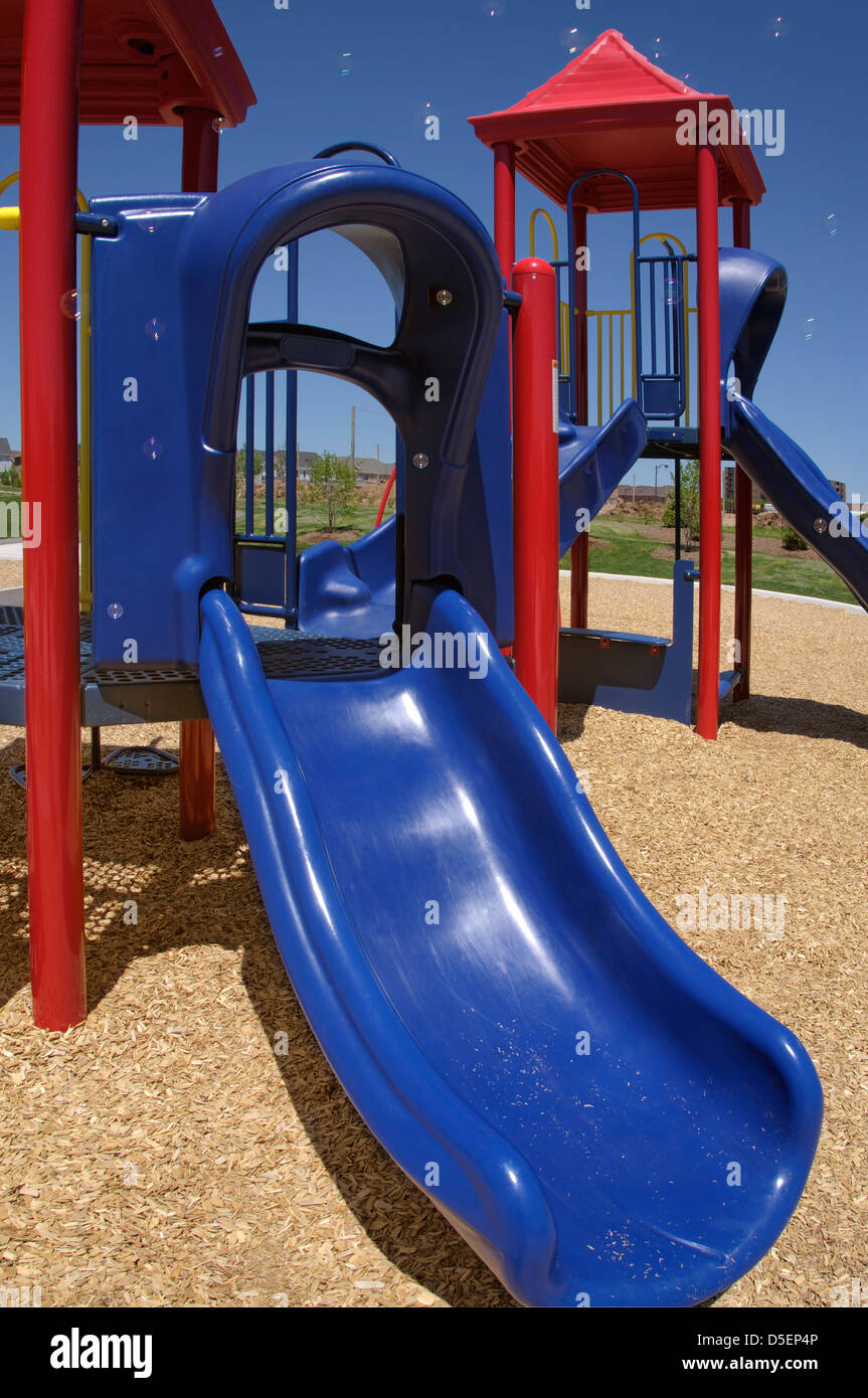 Blue and red playground equipment, and soap bubbles Stock Photo - Alamy