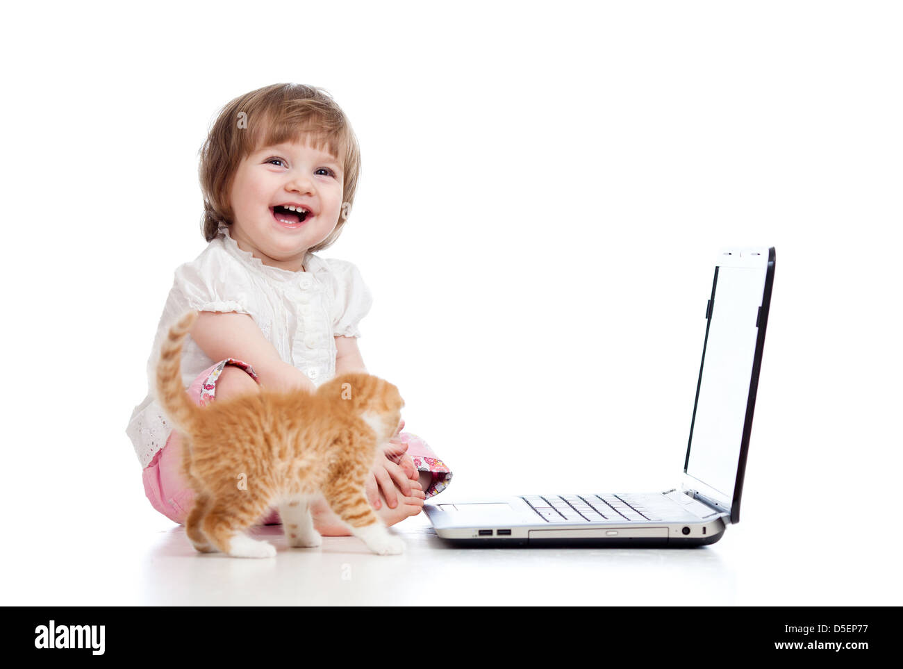 Funny child using a laptop over white background with kitten Stock ...