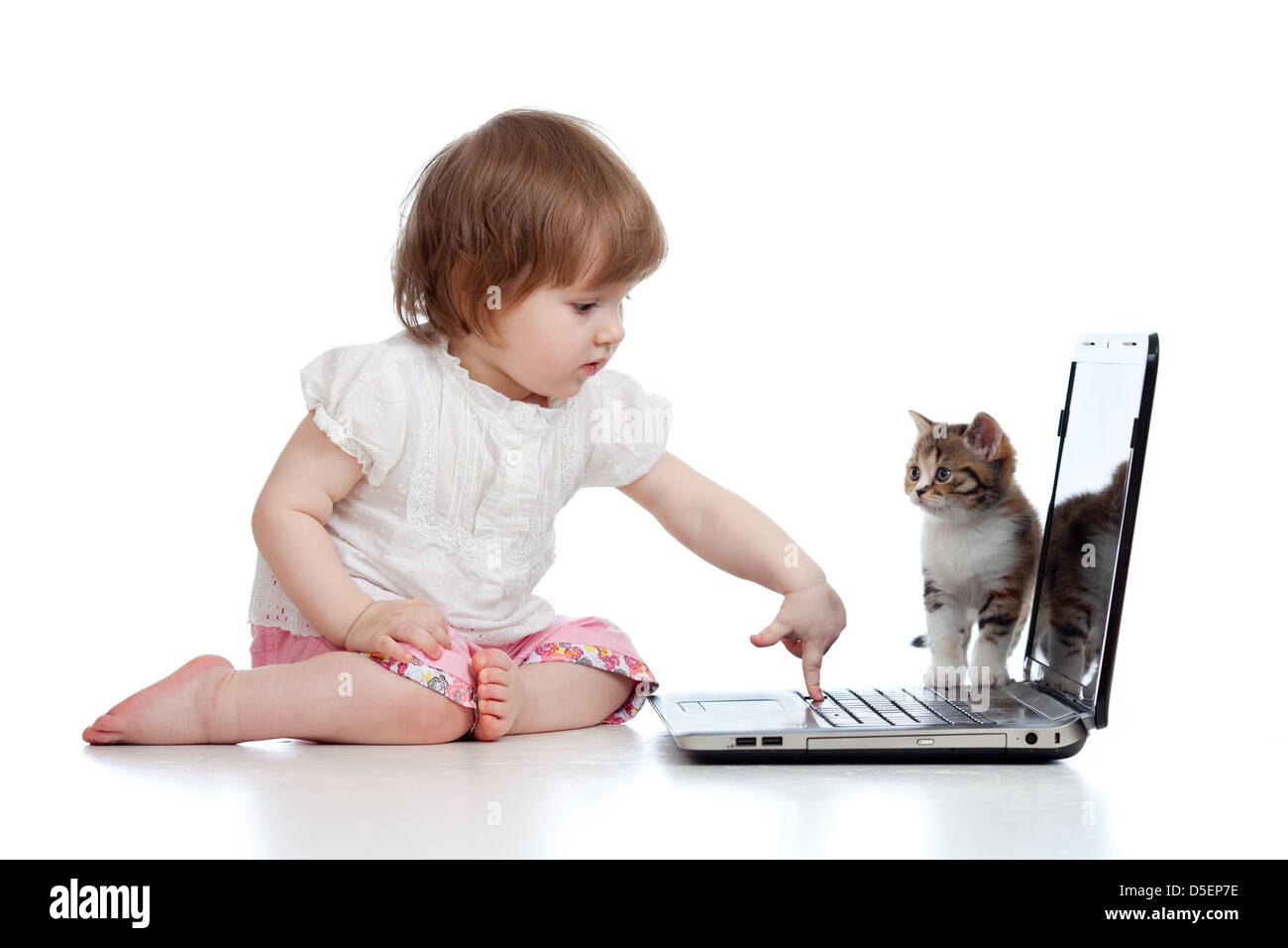 Funny child using a laptop over white background with kitten Stock ...
