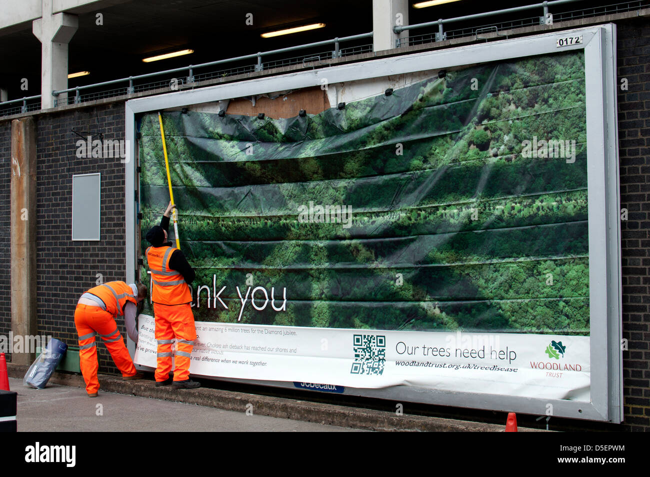 Men putting up billboard poster, Coventry railway station, UK Stock ...