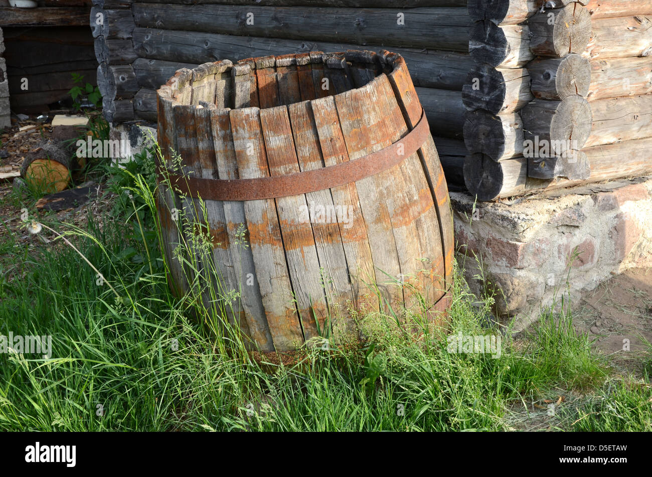 old aged wooden barrel on grass near farm barn Stock Photo - Alamy