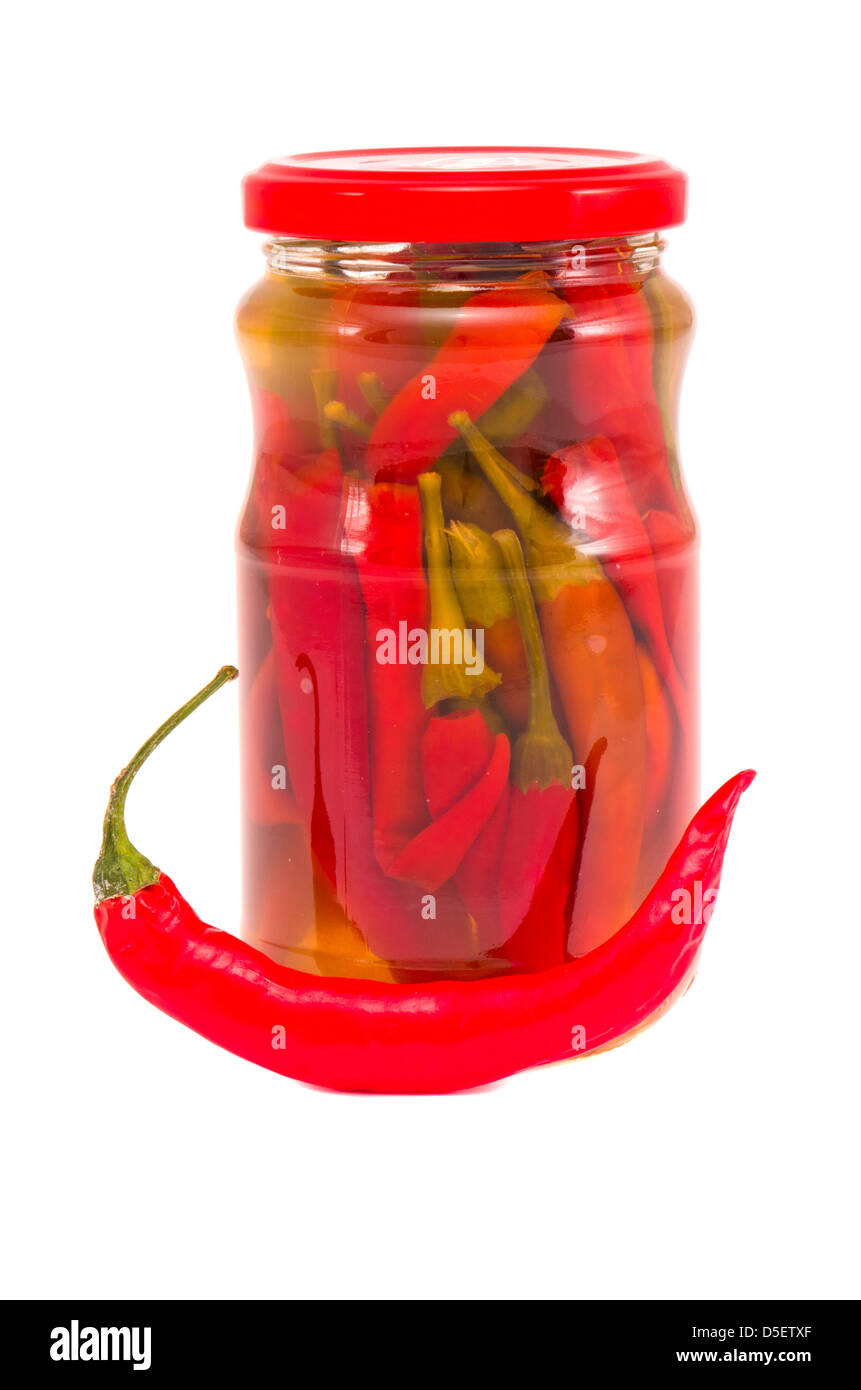 potted red peppers in glass jar isolated on white Stock Photo - Alamy