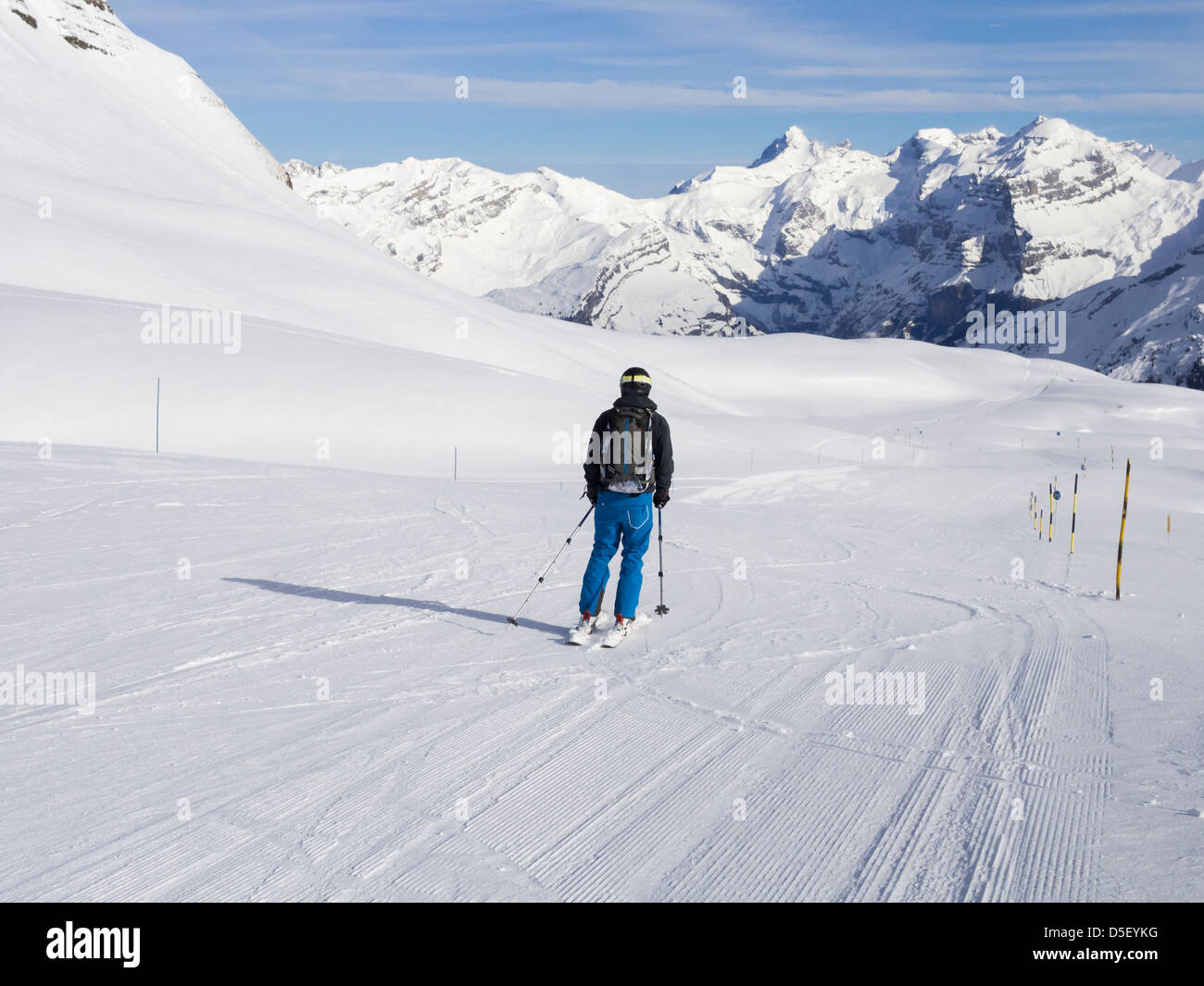 One skier skiing down 14 km blue run Les Cascades in Le Grand Massif ...