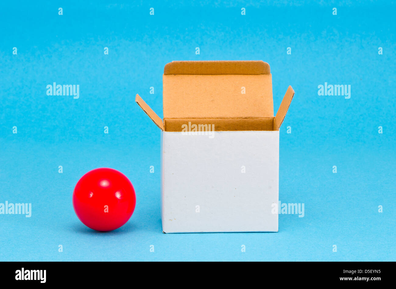 package paper box and billiards ball on azure background Stock Photo ...