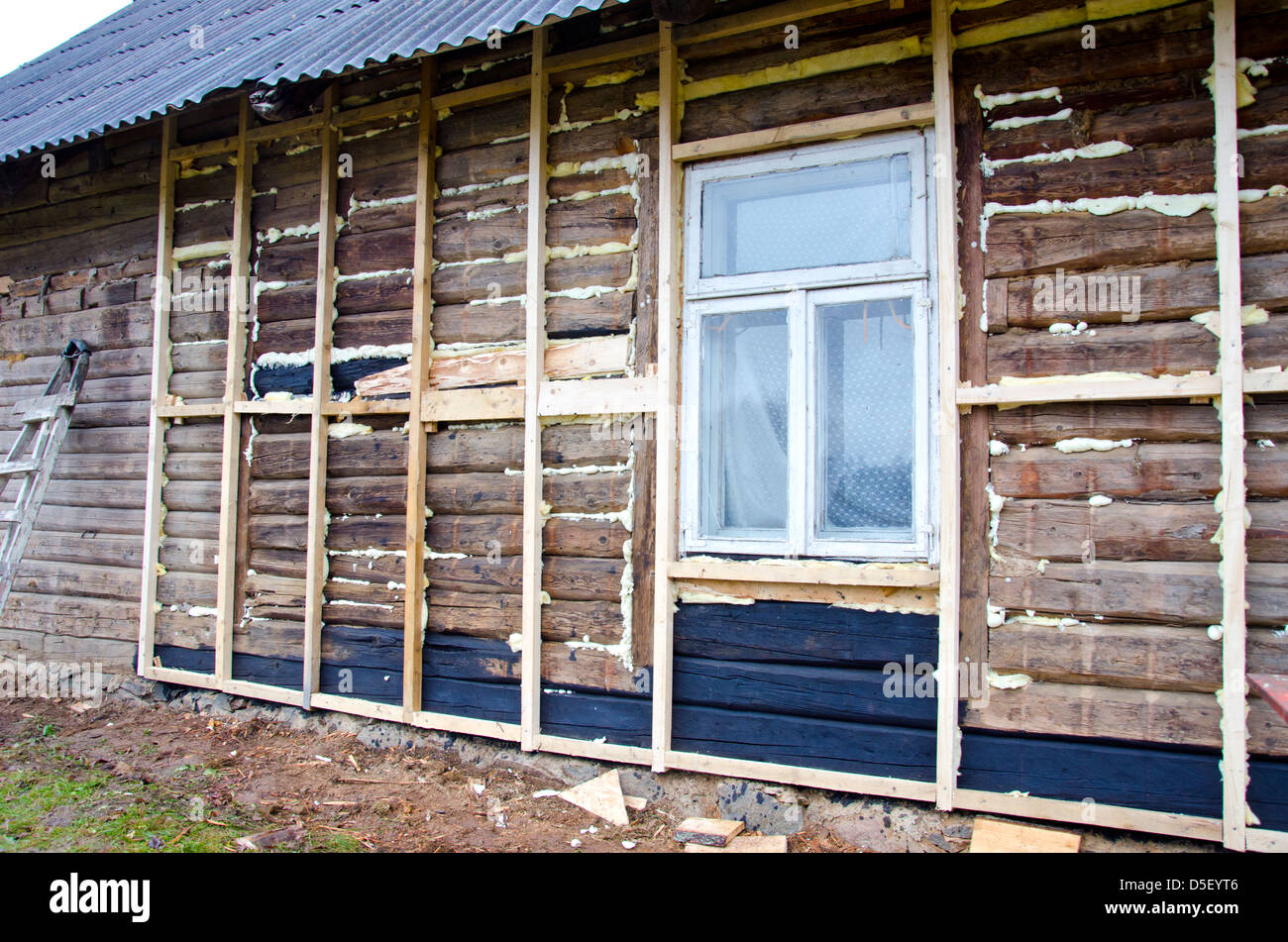 old rural wooden house restoration and insulation works Stock Photo - Alamy