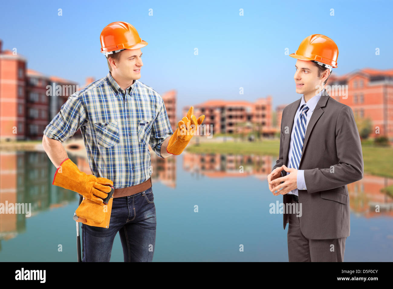 A male manual worker having a conversation with architect, construction ...