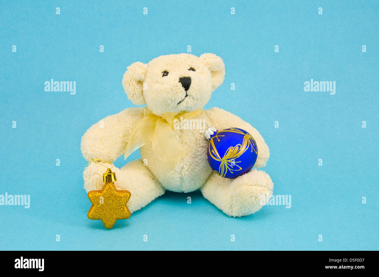 white teddy bear with christmas toys on azure background Stock Photo ...