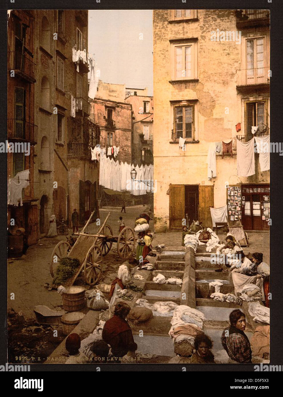A photograph from 1899 showing washerwomen in a street of Naples, Italy ...