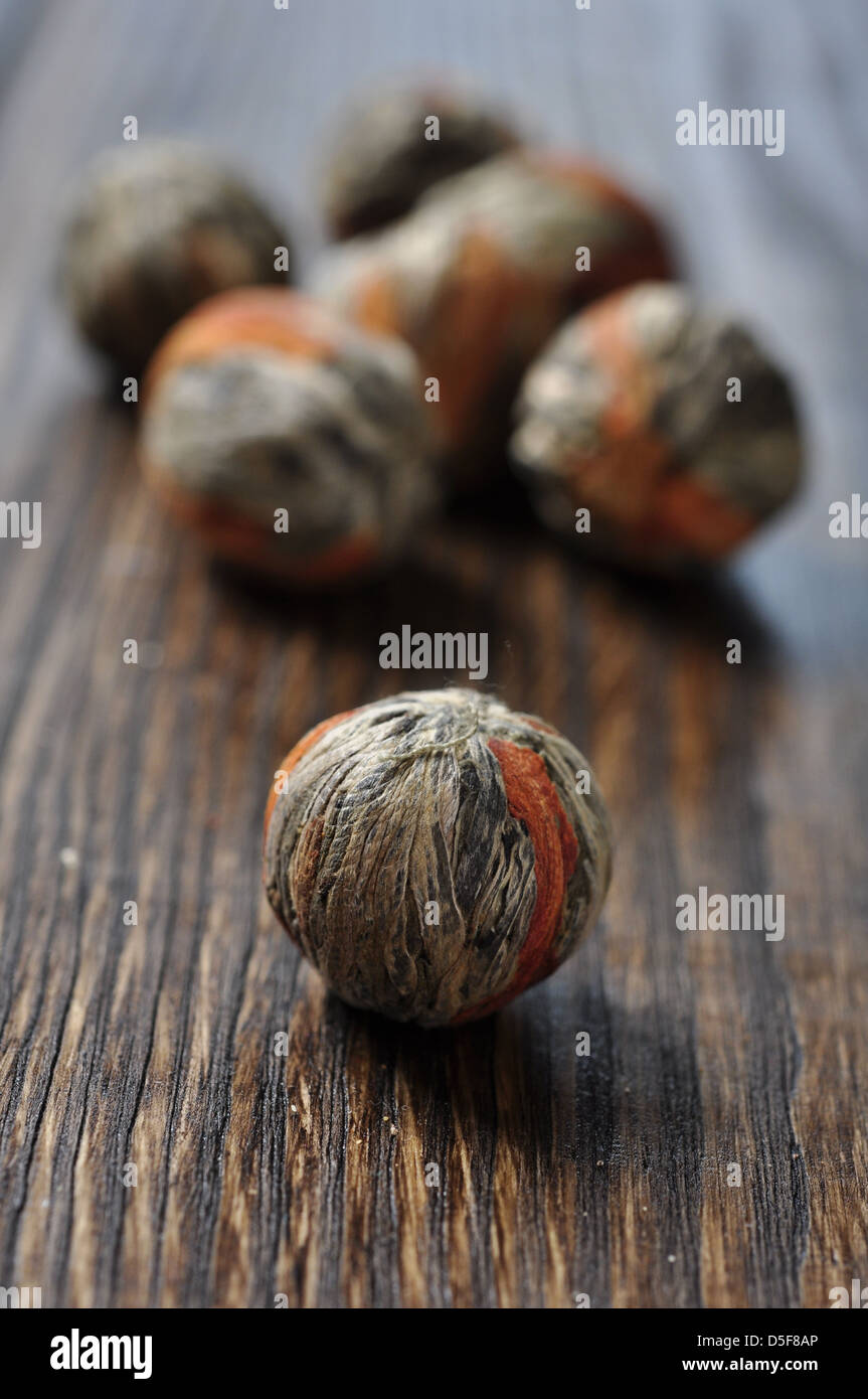 Chinese Green Tea Balls with Lychee Flower on wooden background Stock ...