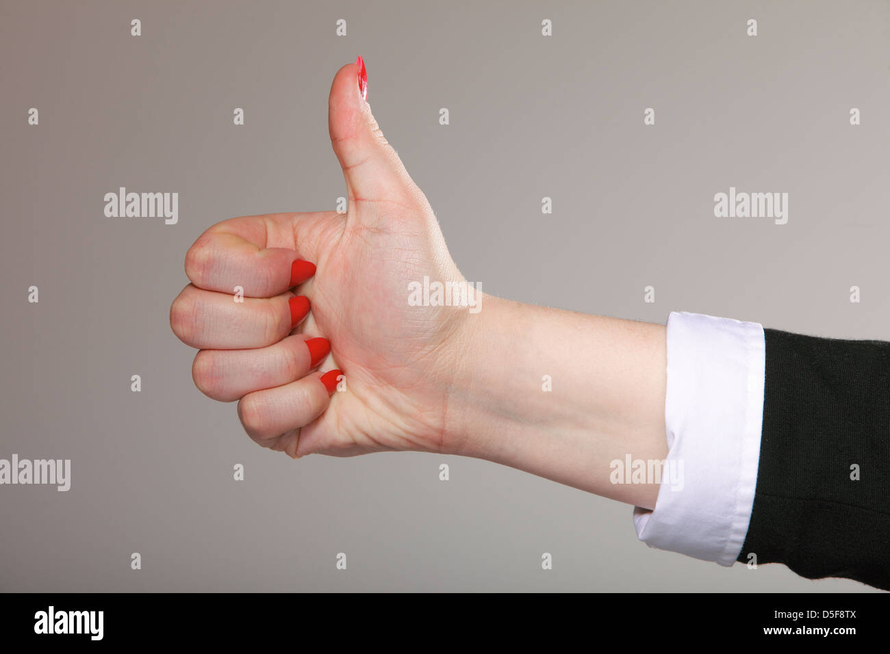 Female hand thumb up gesturing the all right symbol , ok sign gray ...