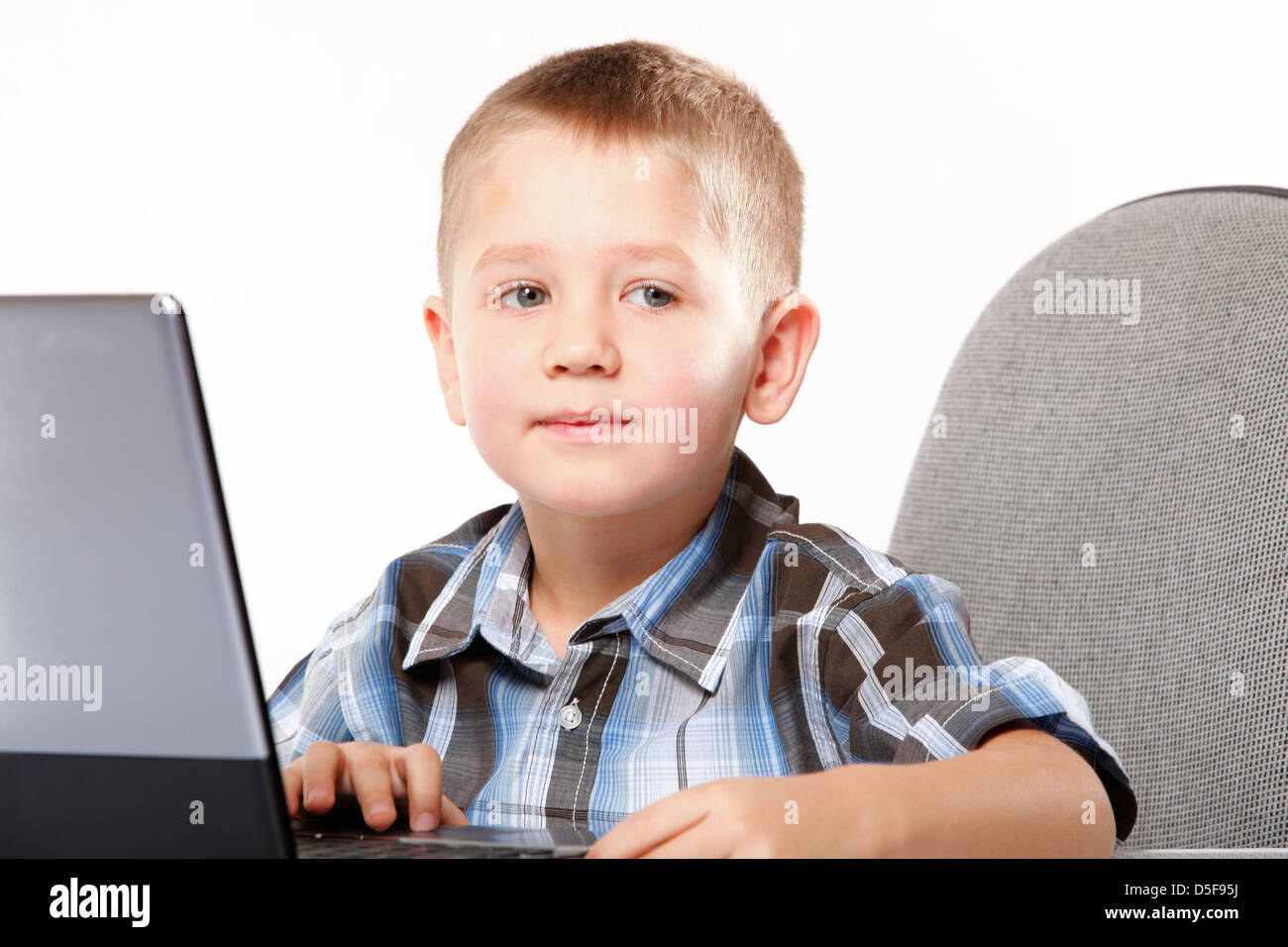 Computer addiction child boy with laptop notebook isolated on white ...