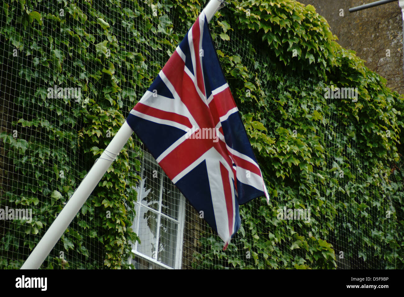 flag waving on a building opposite a window Stock Photo - Alamy
