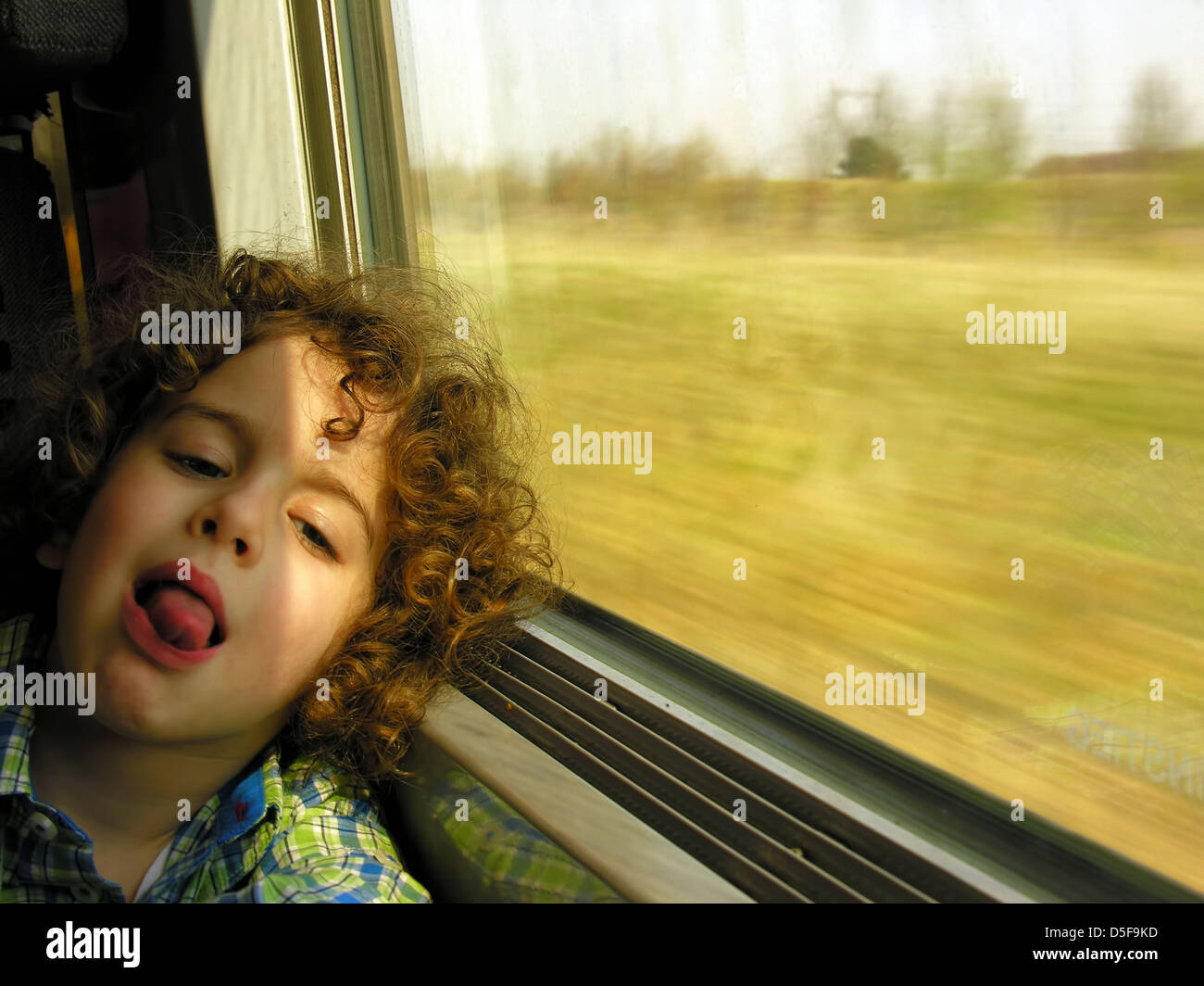 Little boy bored on the train journey Stock Photo - Alamy