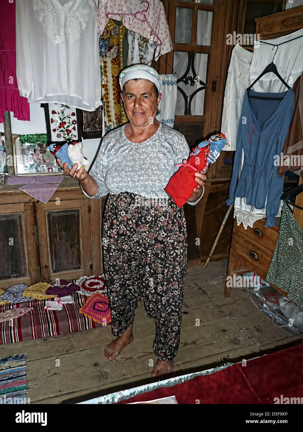 Local village woman shows fabric dolls he sells Stock Photo - Alamy