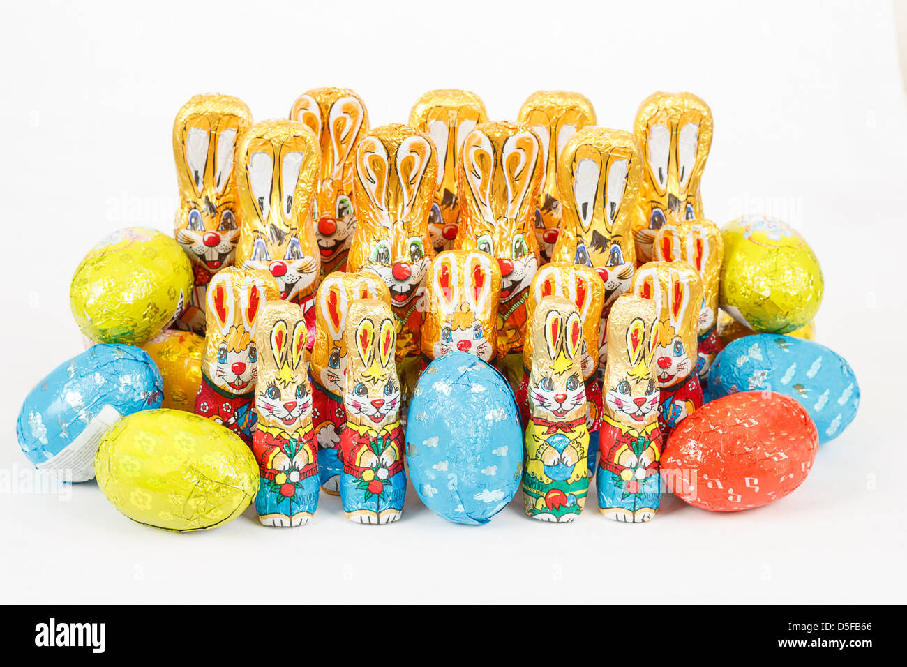 group of many color easter chocolate rabbits bunny and eggs on white ...