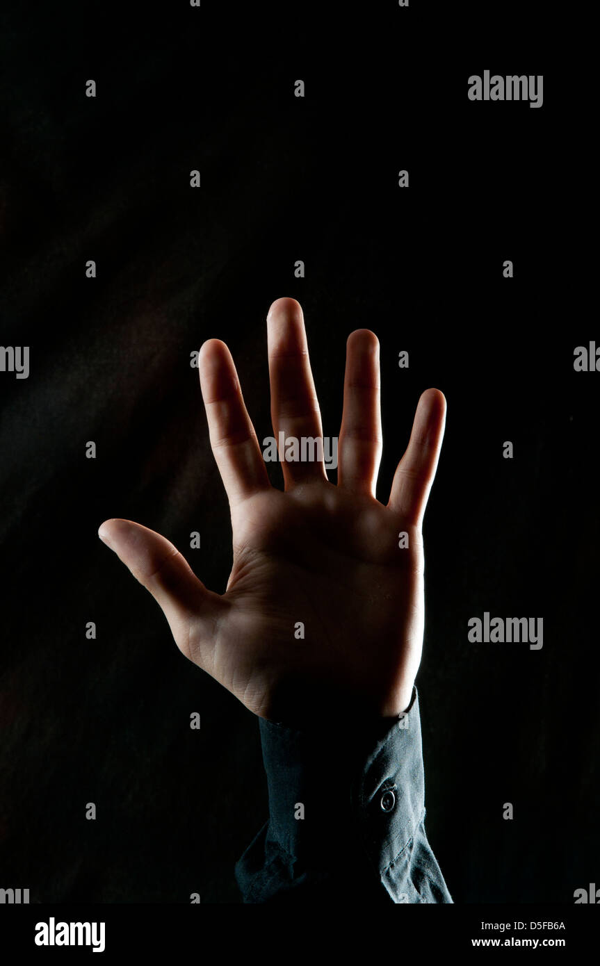 Man's hand in the dark Stock Photo - Alamy