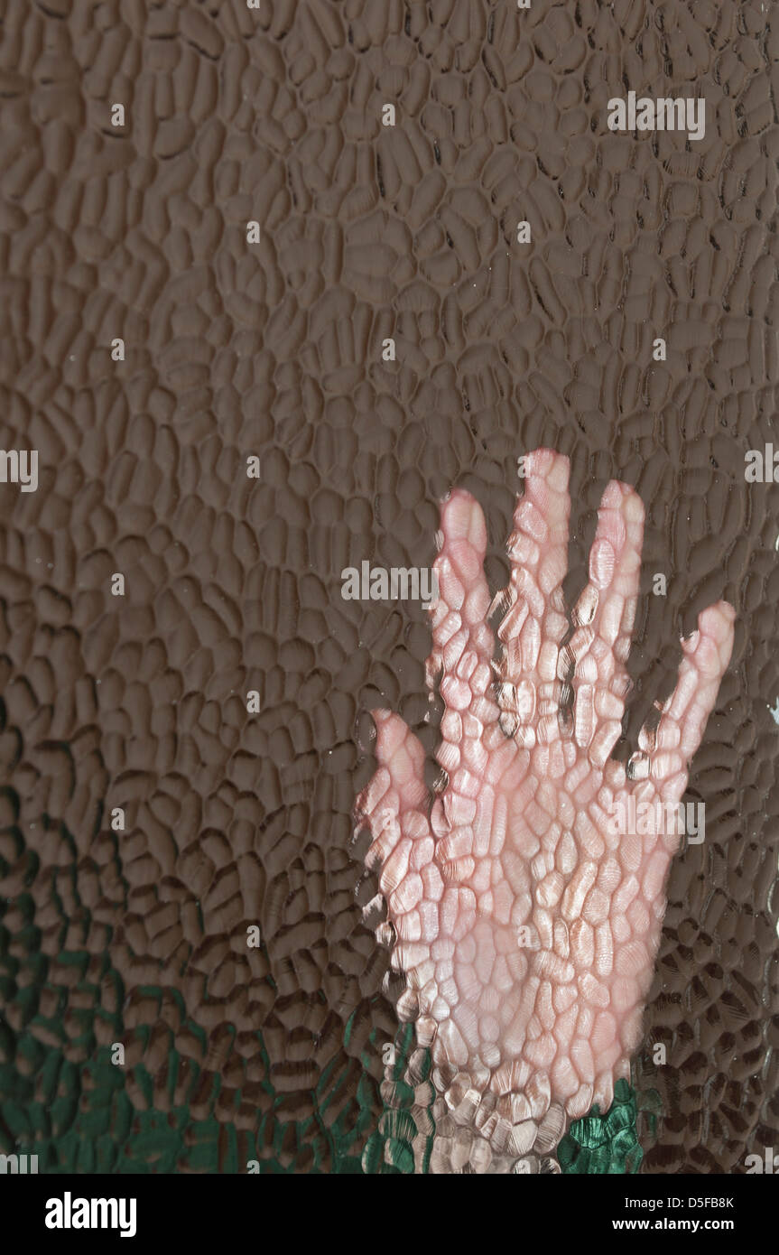 Captive woman's hand pressing against glass Stock Photo - Alamy