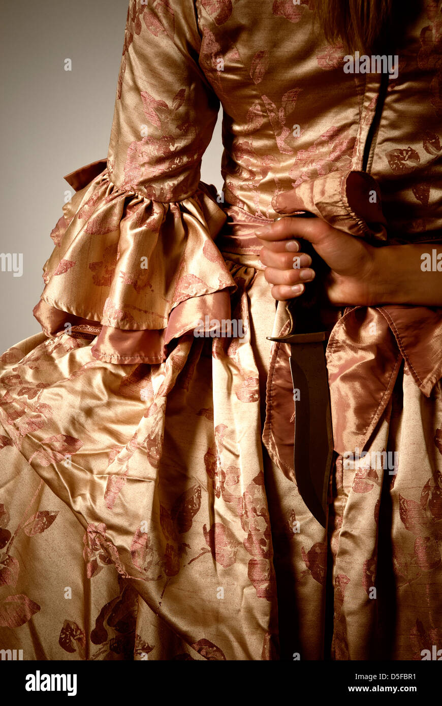 Woman holding knife behind back hi-res stock photography and images - Alamy