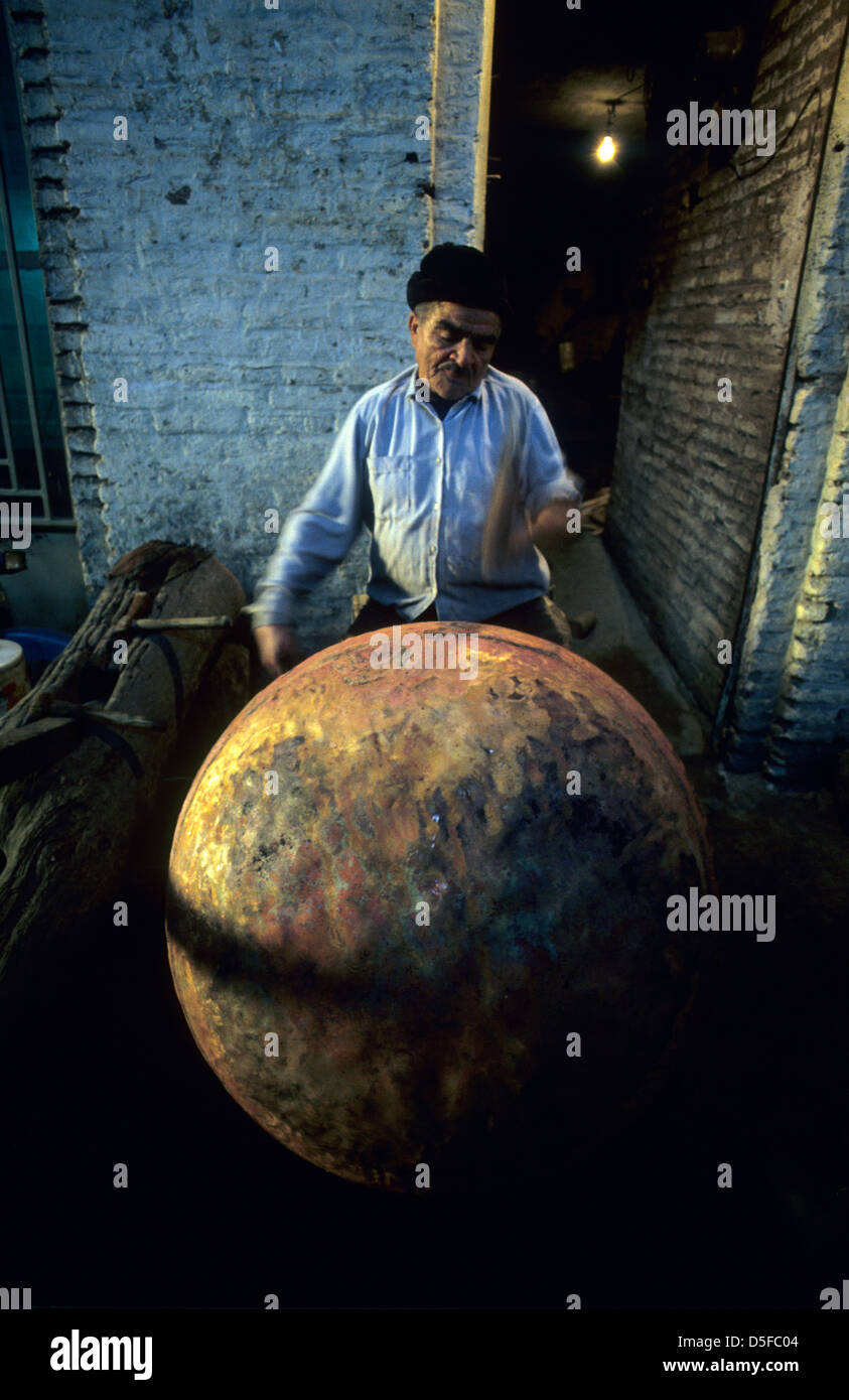 Iran, Tehran, traditional souk, man making copper drum Stock Photo - Alamy