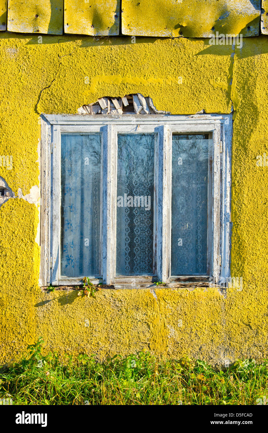 ancient and aged window on old house yellow wall Stock Photo - Alamy