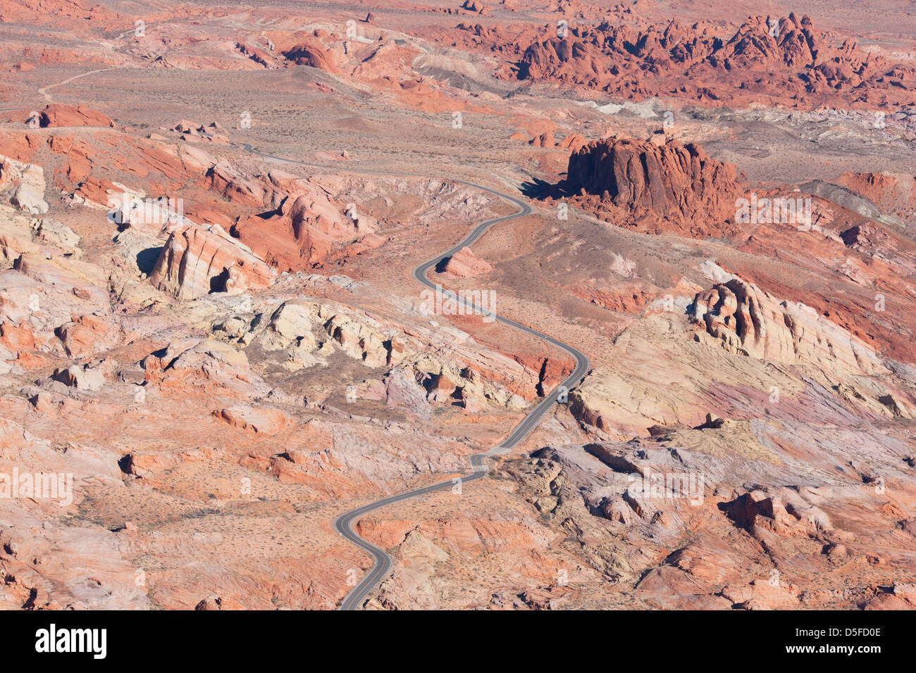 AERIAL VIEW. Winding scenic road in a colorful sandstone rock formation ...