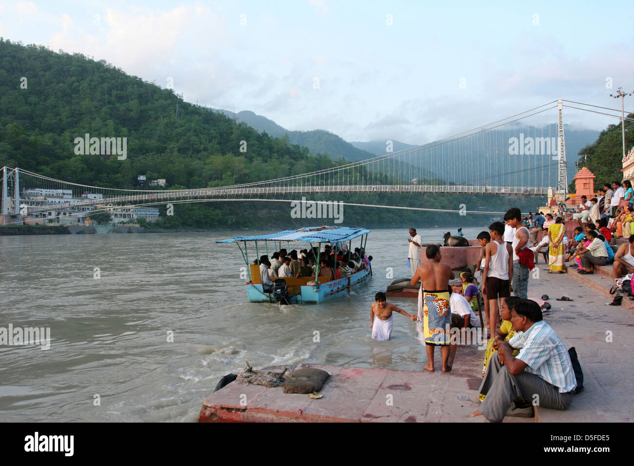Tourists and pilgrims on the ghats below Shivanand Jhula Bridge in ...