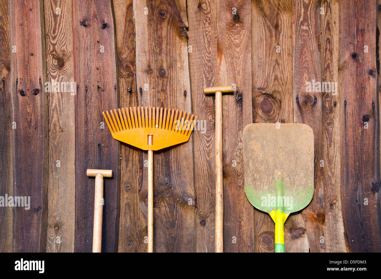 farmers tools on old wooden barn wall background Stock Photo - Alamy