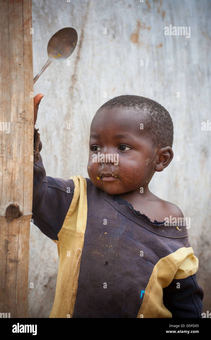 African child eating in Cameroon with bowl and spoon Stock Photo - Alamy