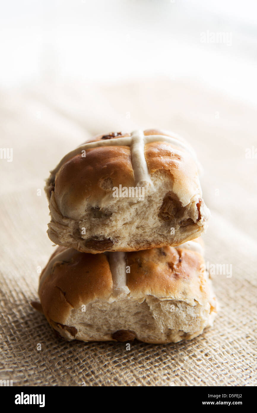Two hot cross buns, placed on a brown textured background Stock Photo ...