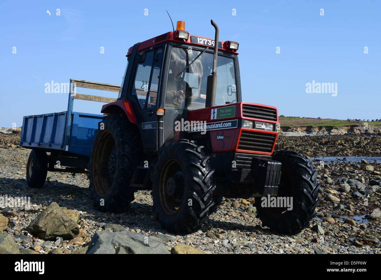 Tractor crossing causeway to Lihou Island on Guernsey Stock Photo - Alamy