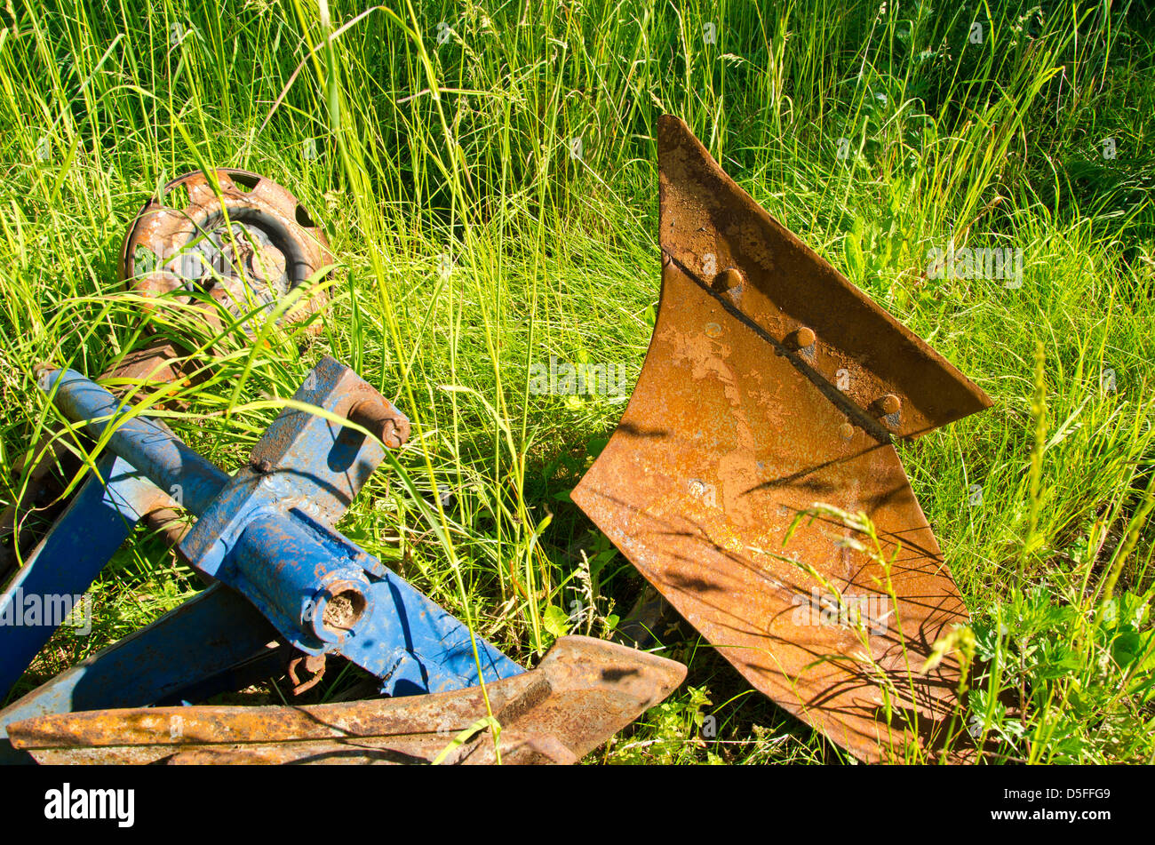 old rusty tractor plow on summer grass in farm Stock Photo - Alamy