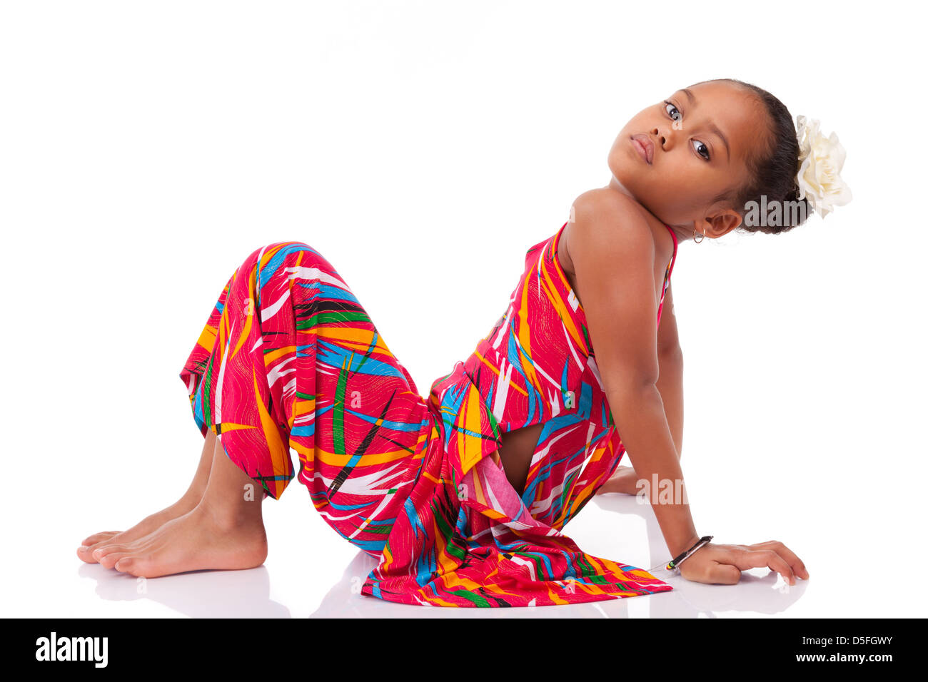 Portrait of a cute young African Asian girl seated on the floor Stock ...