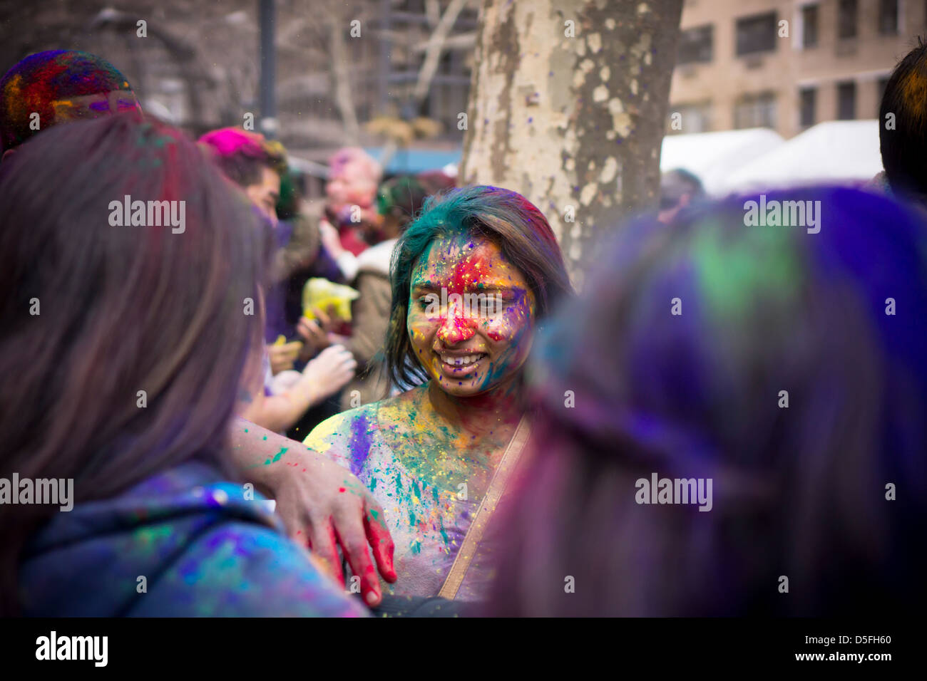 Colored powder is applied to the faces of participants as they ...