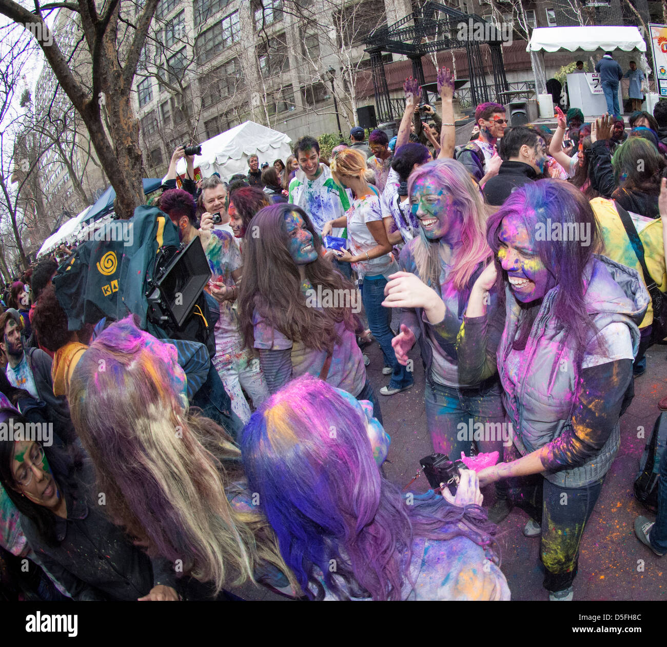 Colored powder is applied to the faces of participants as they ...